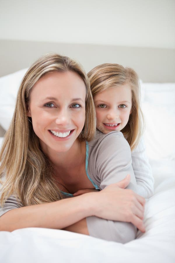 Girl Laying on Her Mothers Back Stock Photo - Image of laughing ...