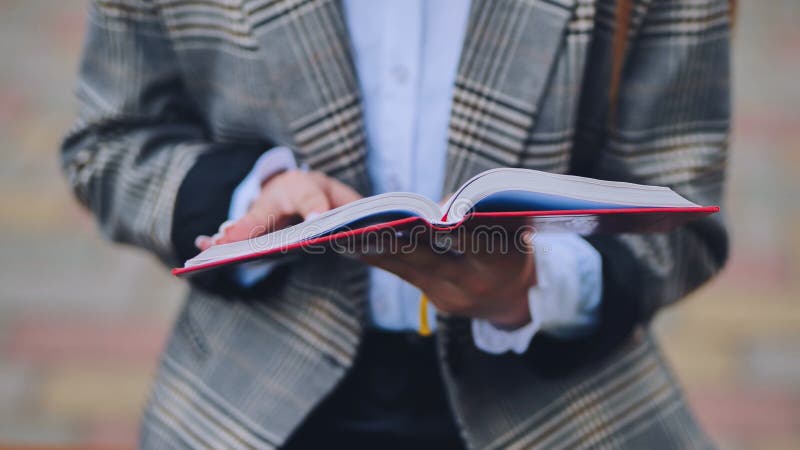 A Girl is Leafing through a Book in the Park. Stock Image - Image of ...