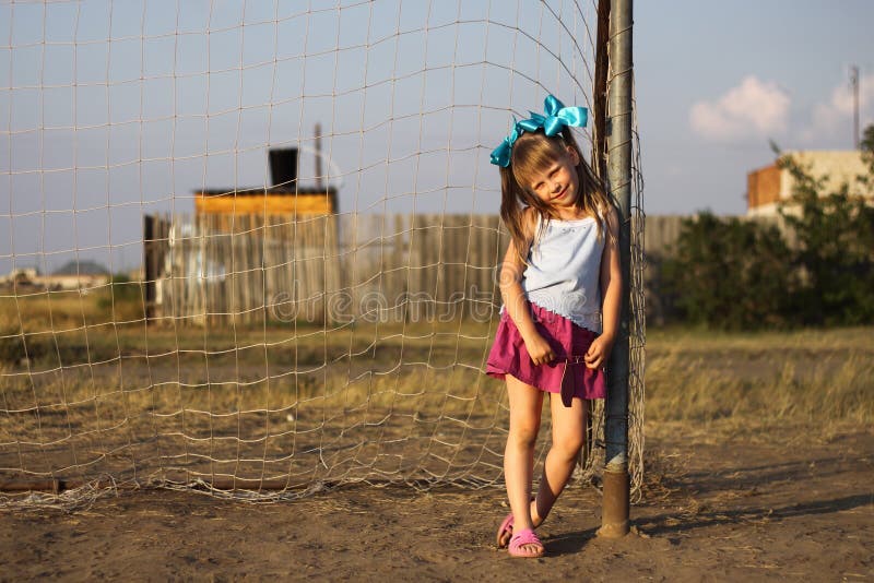 Girl Lean on Football Gate. Stock Image - Image of summer, gate: 27053029