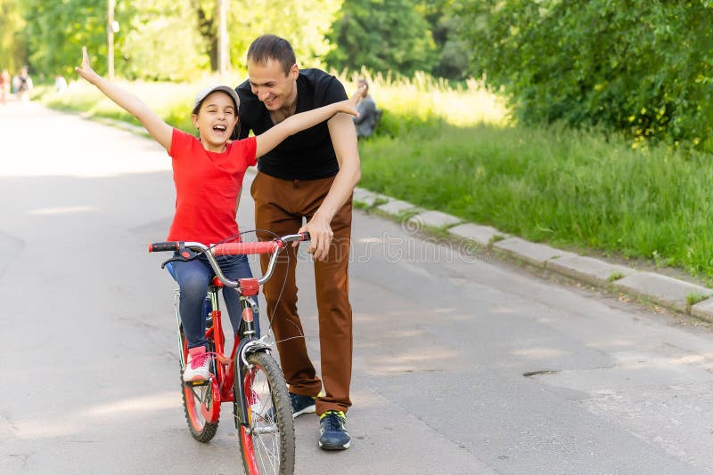 Girl learning to ride bike stock photo. Image of explain - 238937292