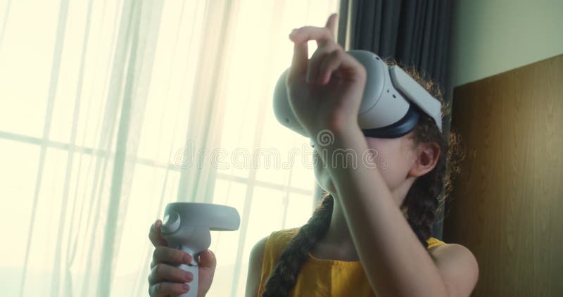 Modern Education Child in Virtual Reality Glasses, Girl Immersed in ... Modern Education Child in Virtual Reality Glasses, Girl Immersed in ...