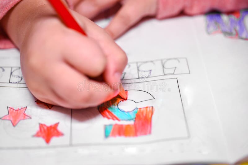 A Girl Learns To Count, a Girl Colors a Number Five with a Pencil ...