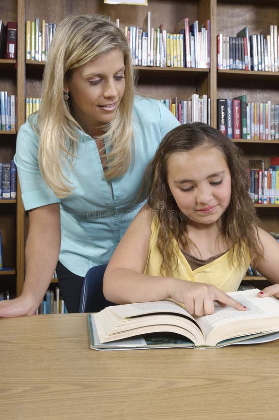 Girl and Librarian Reading Book Stock Image - Image of bookcase, child ...