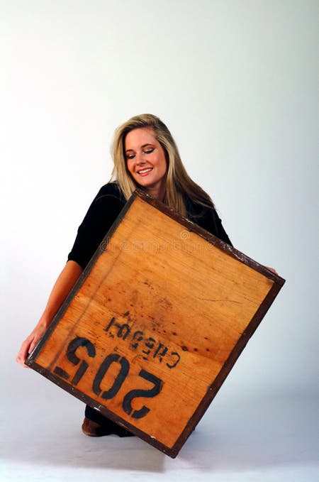 Girl lifting a heavy box stock image. Image of difficult - 283871