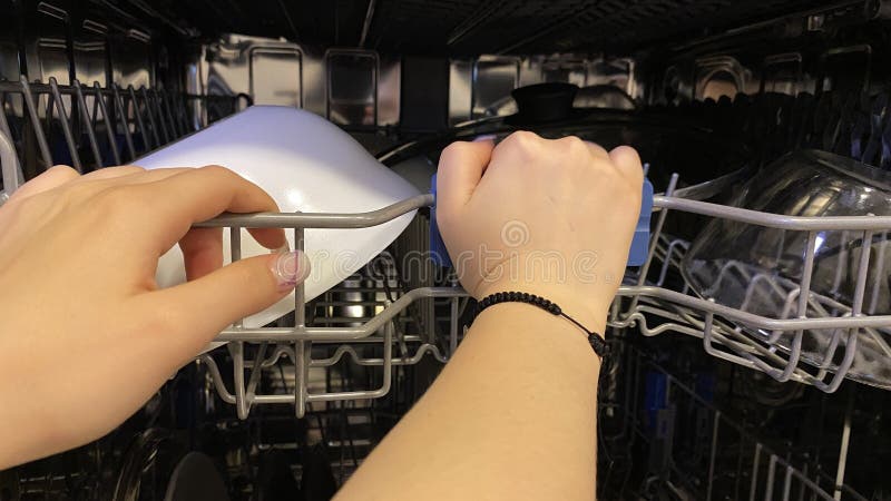 Girl Loading Dishwasher in Modern Kitchen Interior with Clean Tableware ...