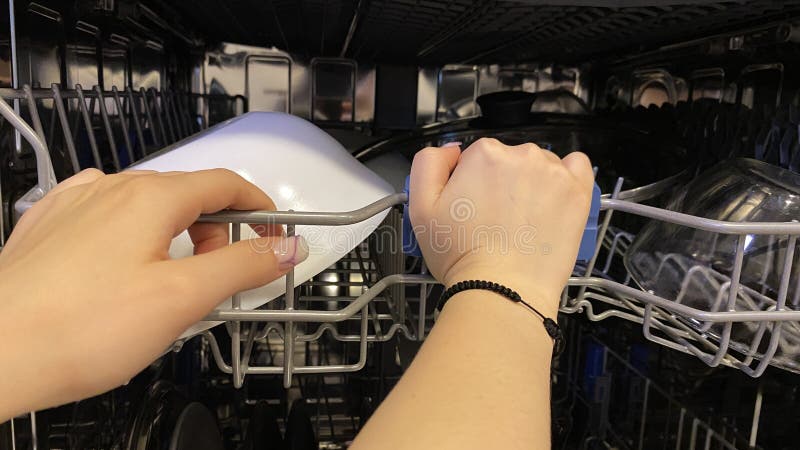 Girl Loading Dishwasher in Modern Kitchen Interior with Clean Tableware ...