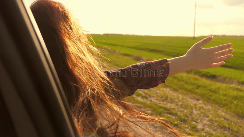 Girl With Long Hair Is Sitting In Front Seat Of Car Stretching Her Arm