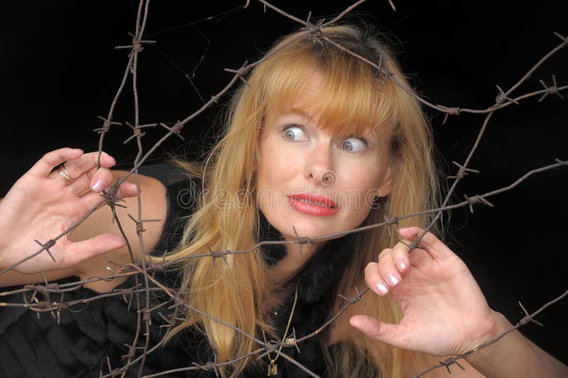 Girl Looking through Barbed Wire Stock Image - Image of beige, blonde ...