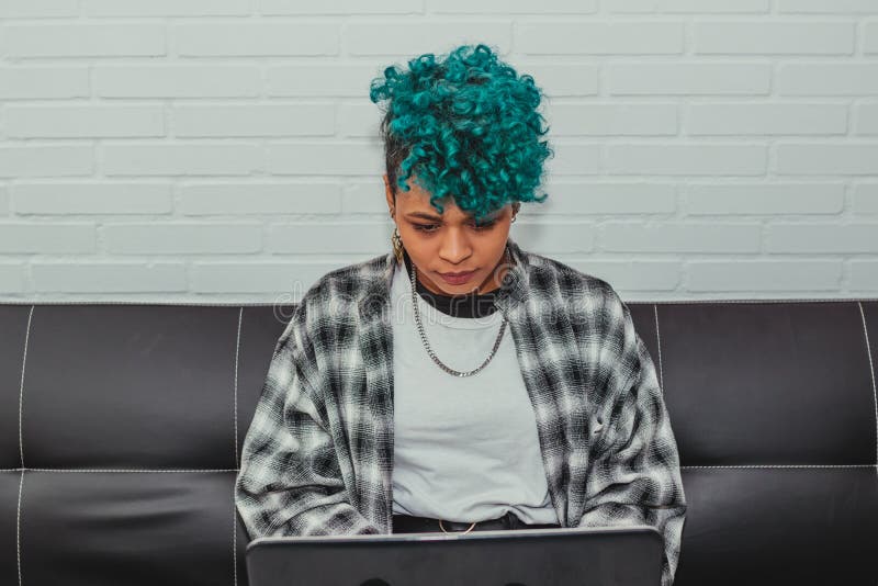 Girl Looking at the Computer Sitting on the Sofa Stock Photo - Image of ...