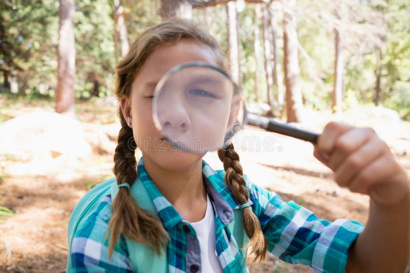 Girl Looking through Magnifying Glass in the Forest Stock Photo - Image ...