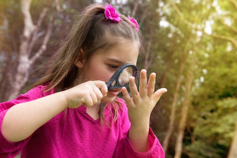 Girl Looking through a Magnifying Glass Stock Image - Image of ...