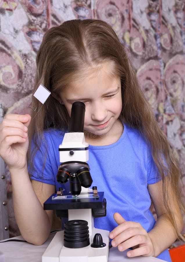 Girl Looking through a Microscope Stock Image - Image of childhood ...
