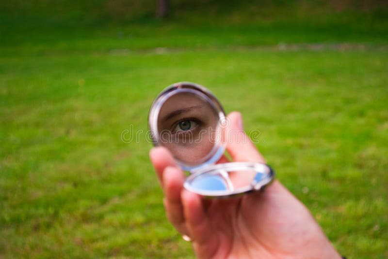 Girl Looking in a Small Mirror in Her Hand Stock Photo - Image of hand ...