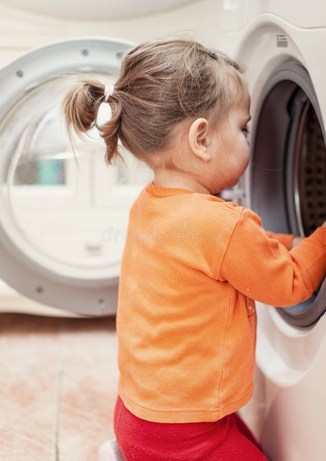 Girl is Looking into the Washing Machine Stock Photo - Image of ...