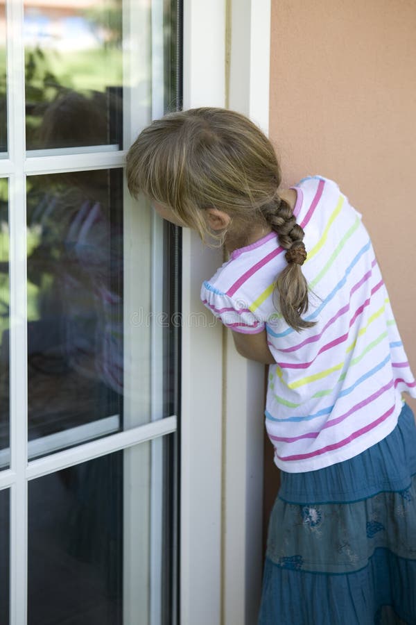 Girl looks out the window stock image. Image of girl - 12102787