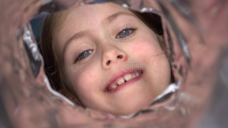 The Girl Looks into a Pack of Snacks and Eats. the Child Eats Chips ...