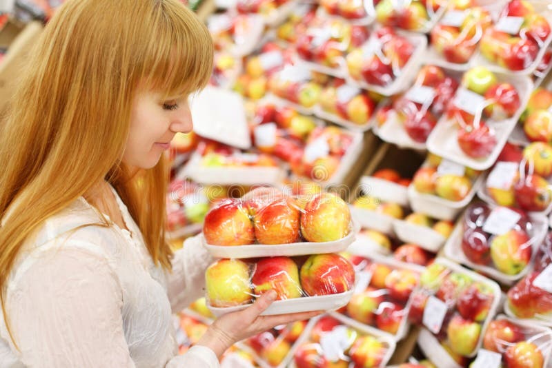 Girl Looks at Packed Apples in Store Stock Image - Image of girl ...