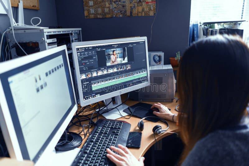 The Girl Looks at the Screens and Processes Video on a Computer with ...
