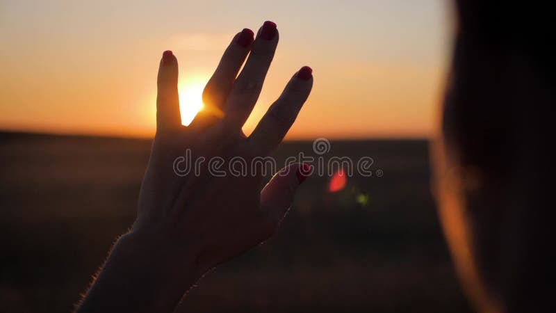 Girl Looks at the Sun through Her Hand at Sunset. Stock Footage - Video ...