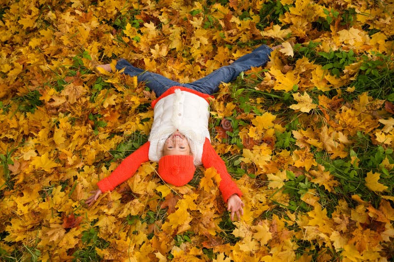 Girl Lying in Autumn Leaves Stock Photo - Image of forest, fall: 10426426