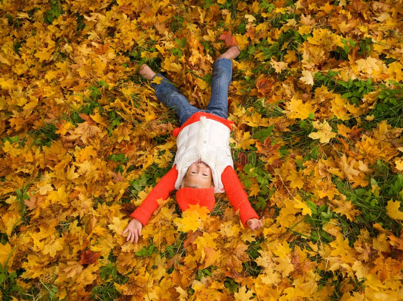Kids buried in fall leaves stock photo. Image of youth - 7583364