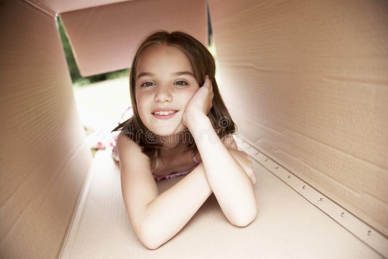 Girl Lying in Cardboard Box Stock Photo - Image of brunet, brunette ...