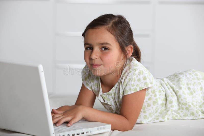 Girl lying with computer stock image. Image of floor - 33285251