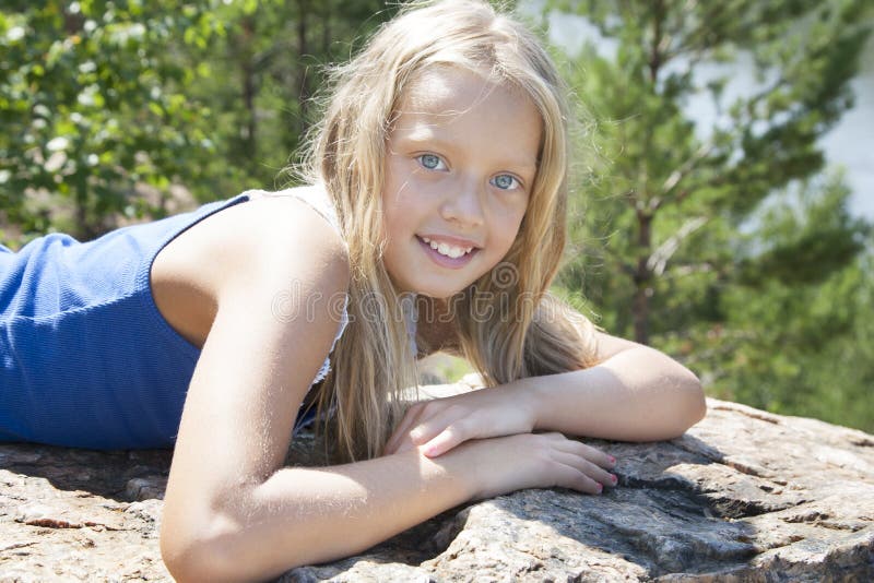 Girl Lying on a Rock and Enjoying Stock Photo - Image of beach, courage ...