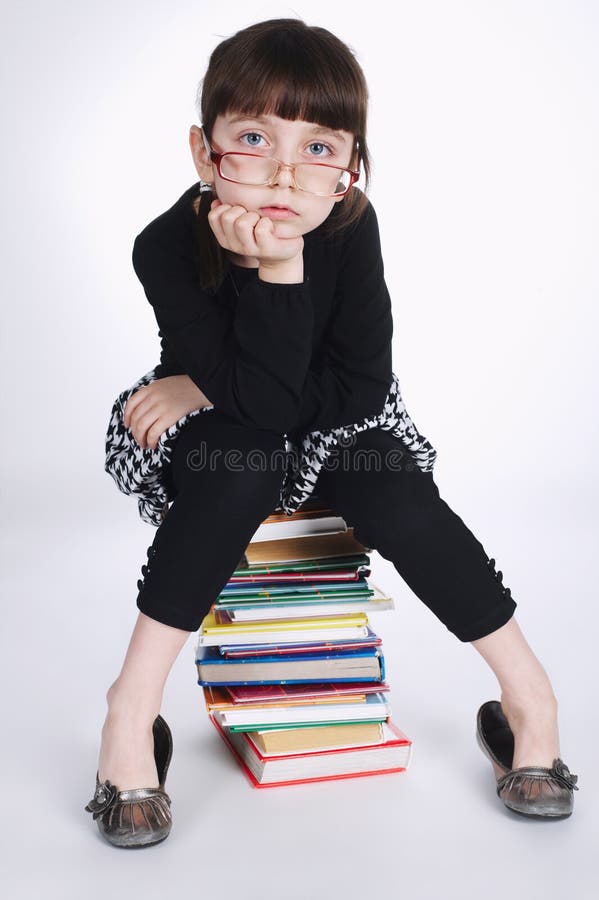 Girl Makes Homework Sitting on Stack Books Stock Photo - Image of ...