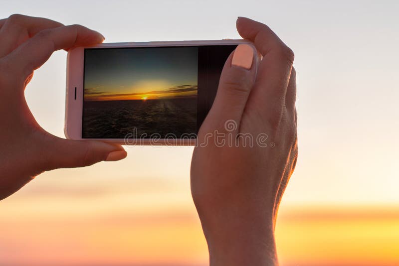 Girl Makes a Photo of Sunset by Phone Stock Photo - Image of hand, girl ...