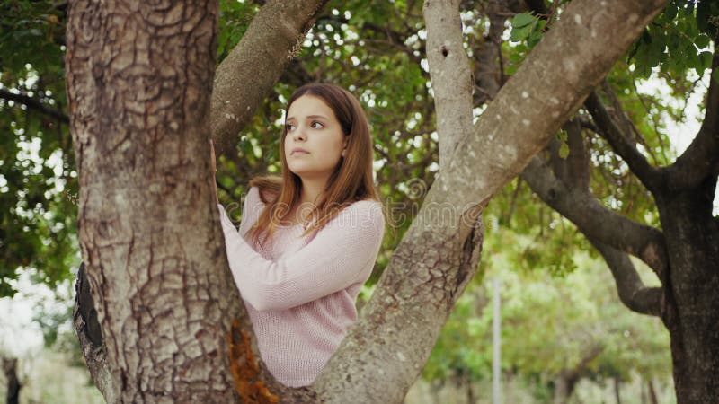 Scared Girl Defends Herself Behind Tree Trunks from the Attacker Stock ...