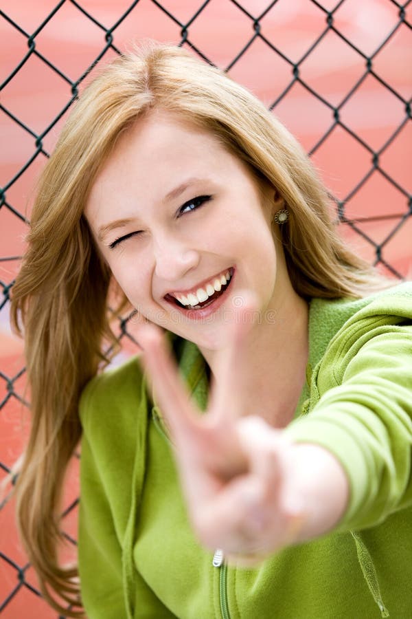 Girl Making Peace Sign stock photo. Image of joyful, teen - 20576116