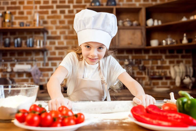 Girl Making Pizza Dough with Pizza Ingredients on Foreground Stock ...