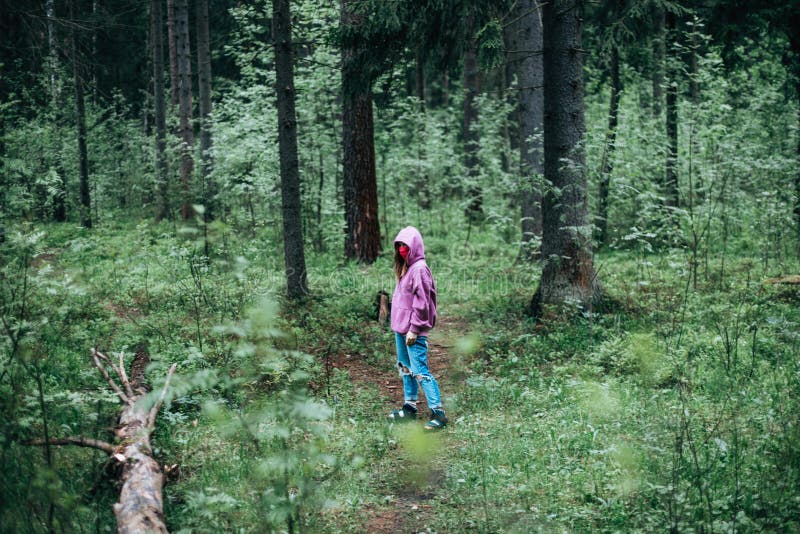 A Girl in a Mask Alone in the Green Forest Stock Photo - Image of ...