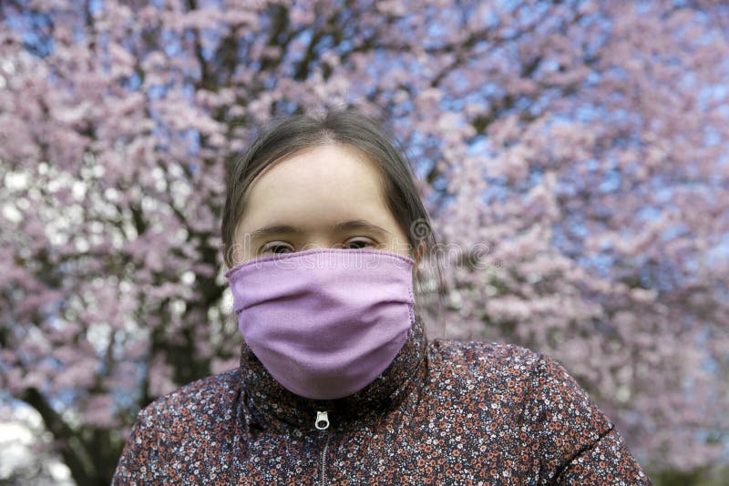 Girl with Mask on Her Face on Background on the Blooming Tree Stock ...