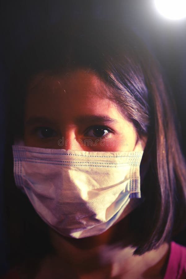 Girl with Mask and Light Behind Creating a Very Dramatic Effect Stock ...