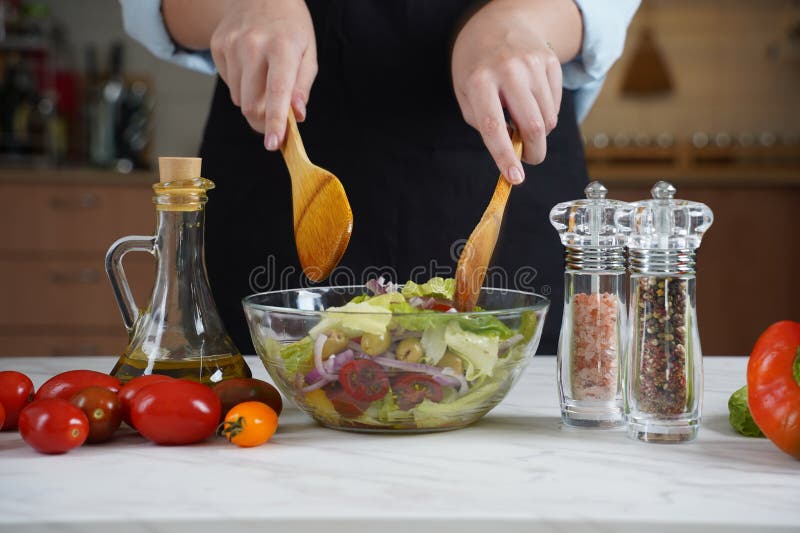 Girl Mixing Salad with Wooden Spoons. the Girl in the Process of Making ...