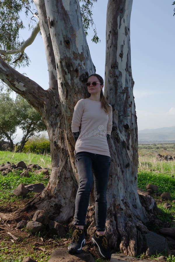Girl Model Posing Standing with Her Back To a Large Tree Stock Photo ...