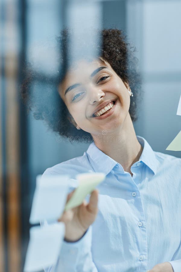 A Girl in a Modern Office Behind Glass Uses Sticky Notes and Makes ...
