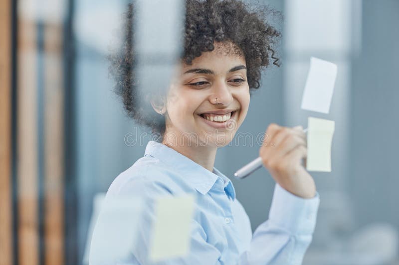 A Girl in a Modern Office Behind Glass Uses Sticky Notes and Makes ...