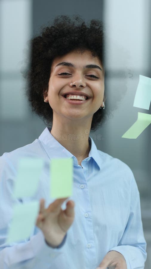 A Girl in a Modern Office Behind Glass Uses Sticky Notes and Makes ...