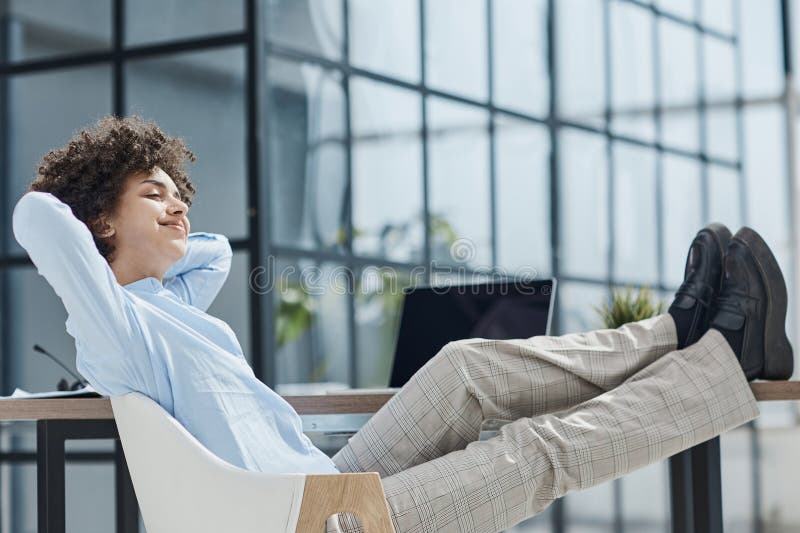 Girl in a Modern Office is Resting. Put Her Feet on the Table Stock ...
