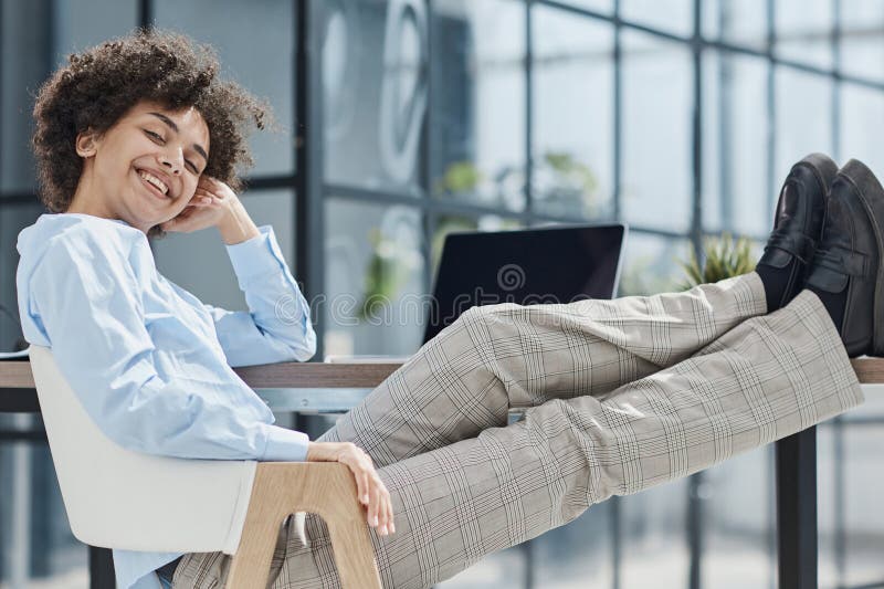 Girl in a Modern Office is Resting. Put Her Feet on the Table Stock ...