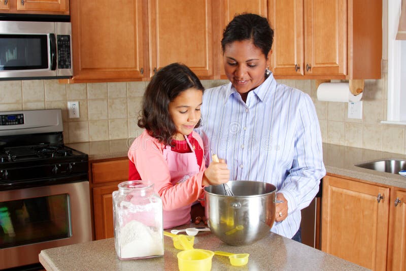Girl and Mother Cooking stock photo. Image of adorable - 7175698