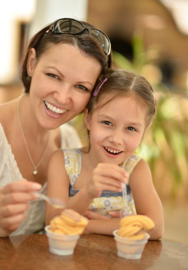 Girl with mother eating stock photo. Image of healthy - 61008146