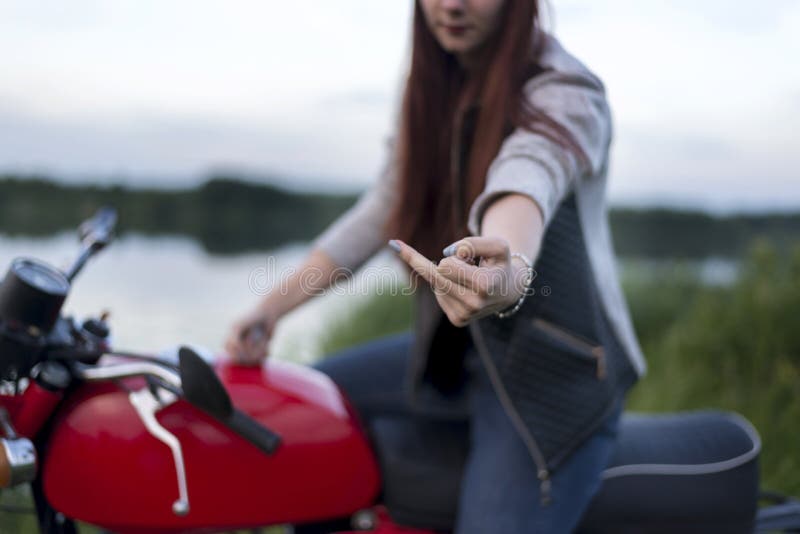 A Girl on a Motorcycle Shows the Middle Finger Stock Image - Image of ...