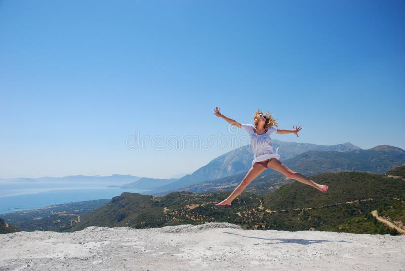 Girl on mountain jumping stock photo. Image of dress - 13427940