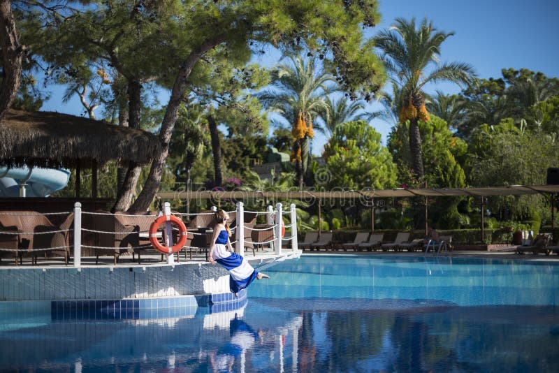 Girl resting near the pool stock photo. Image of club - 155482142