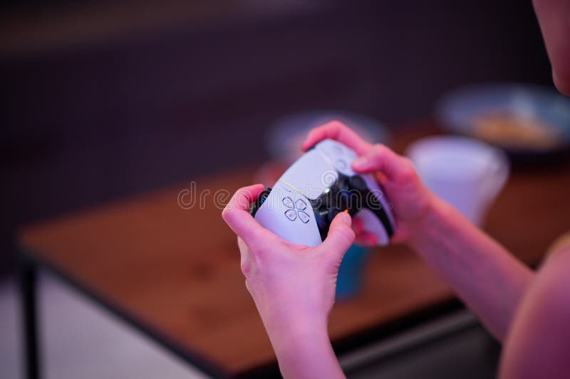 Girl with Next Gen Controller in Her Hands Playing Games at Home. Stock ...