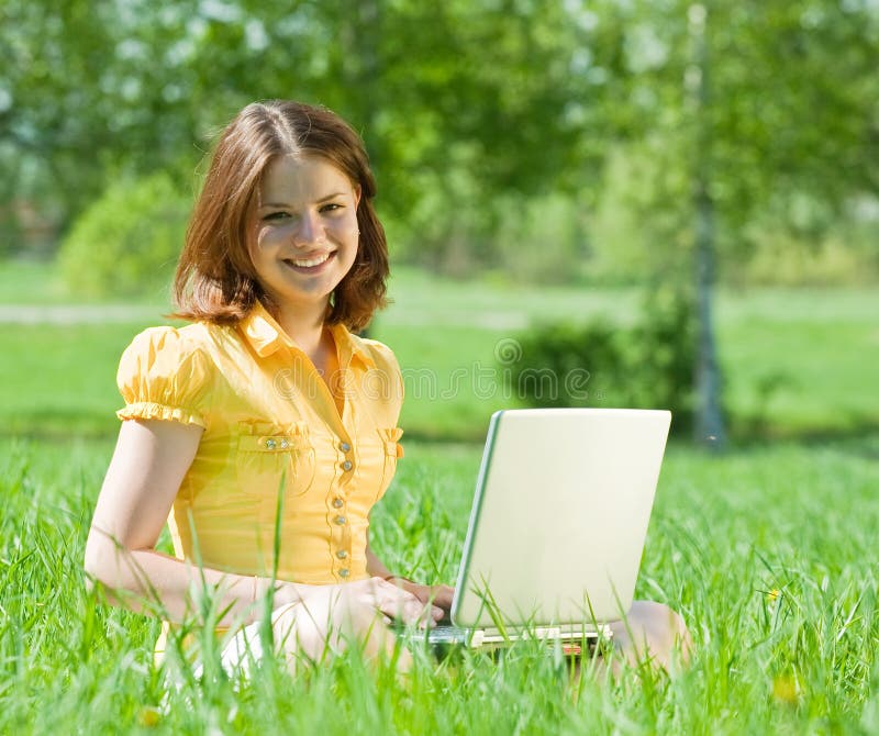 Girl with Laptop. Blonde Beautiful Young Woman with Notebook Sitting on ...